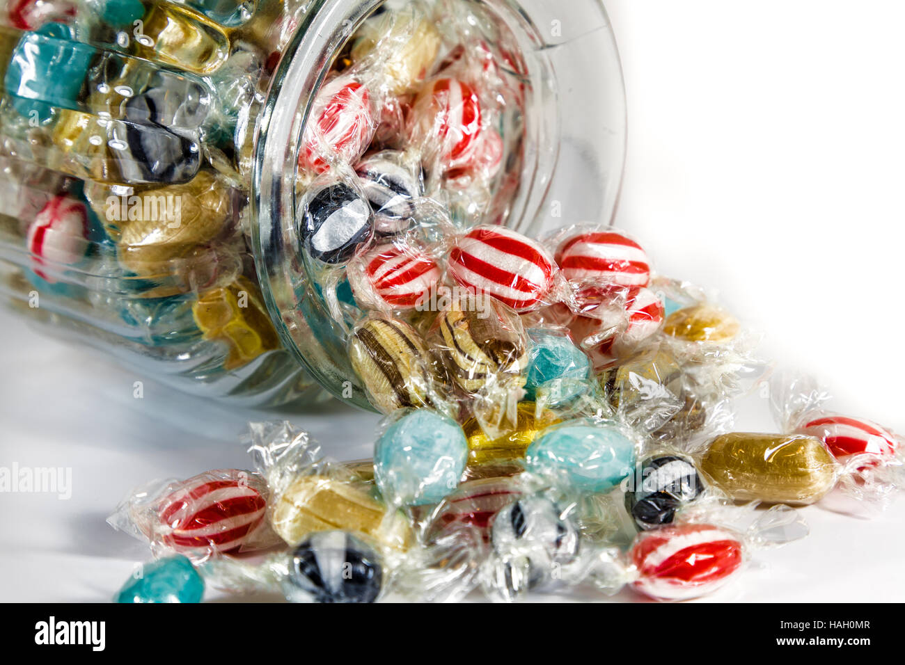 Assorted mint sweets pouring from a glass jar Stock Photo - Alamy