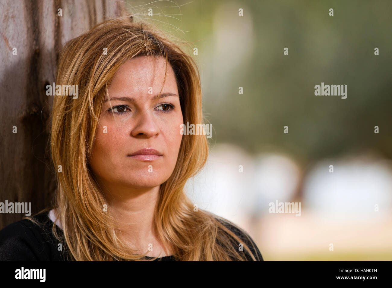 Portrait of a thinking woman outdoor Stock Photo - Alamy