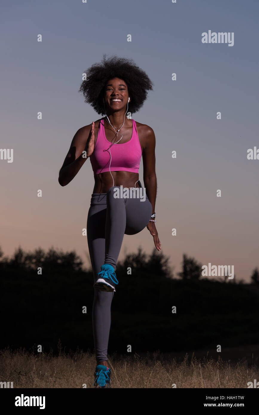 Young healthy black woman is doing stretching exercise relaxing and ...