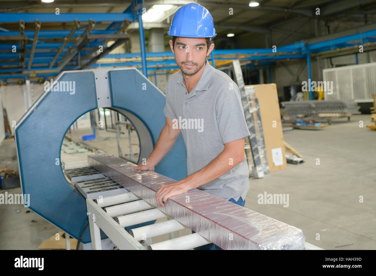 Man working on factory production line Stock Photo - Alamy