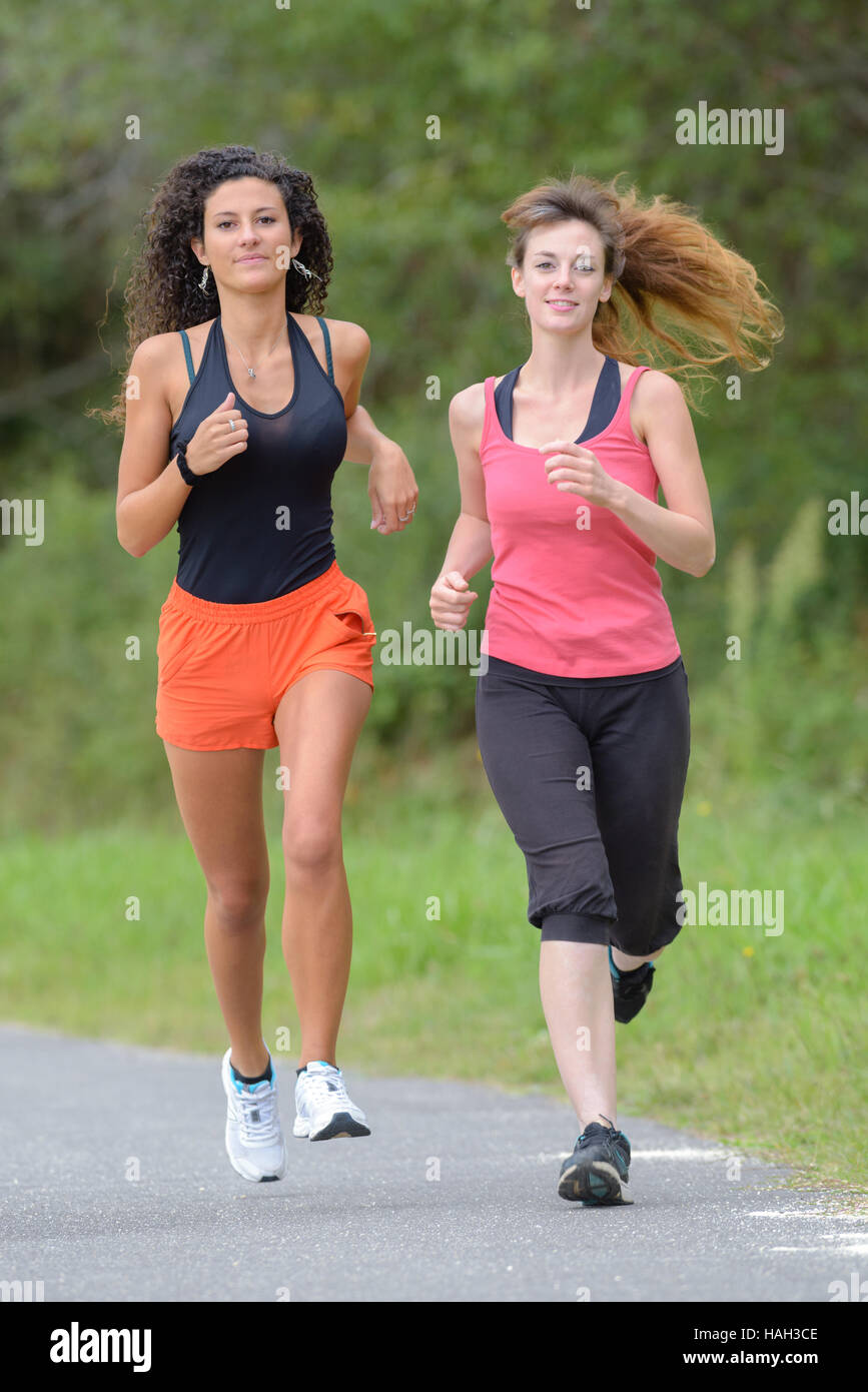 Two women jogging Stock Photo - Alamy