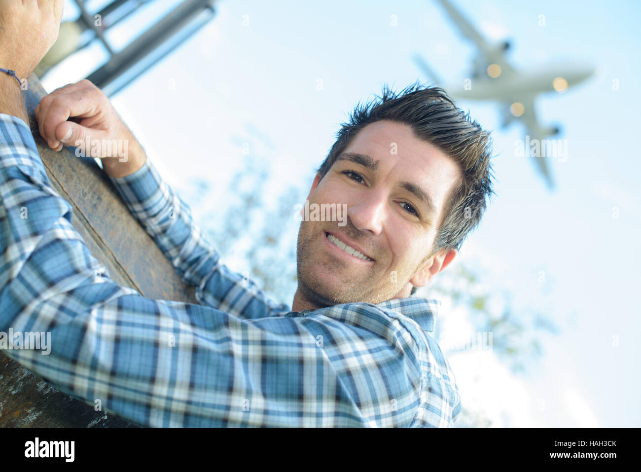 Portrait of man, aircraft in sky Stock Photo - Alamy