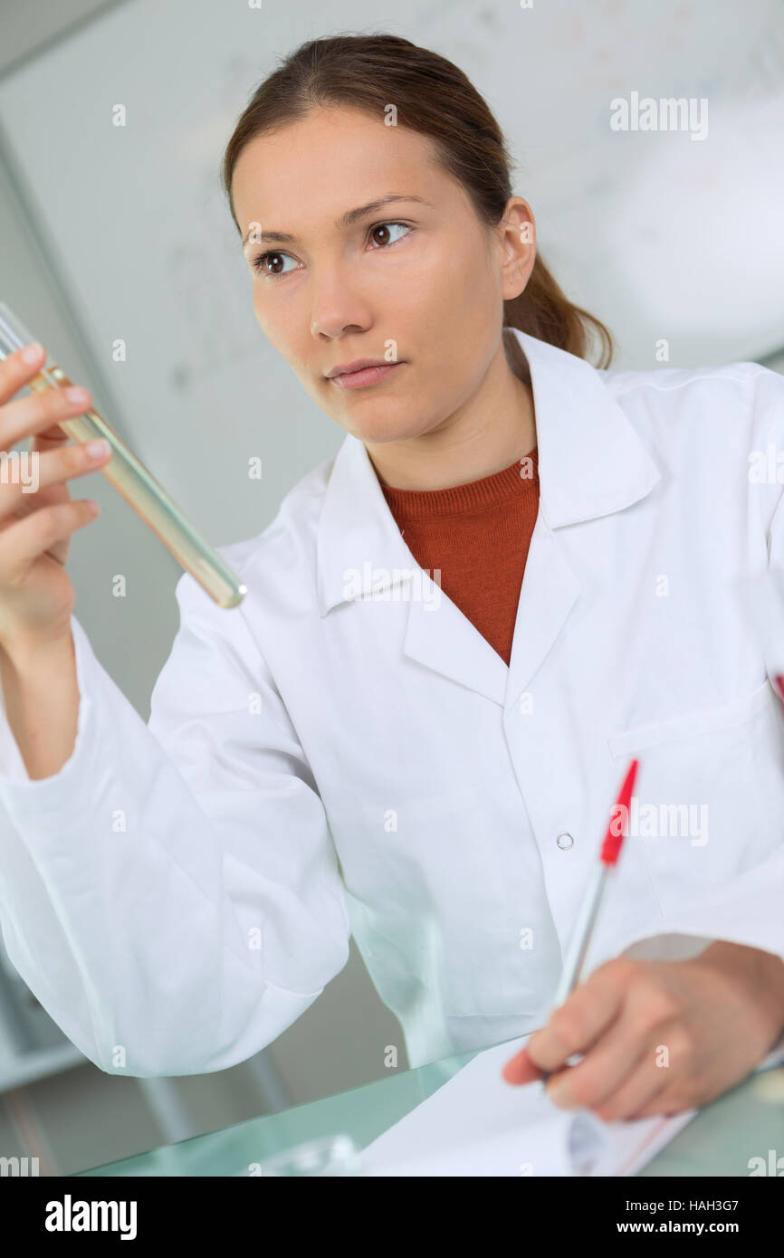 young chemical female researcher working with chemicals in laboratory ...