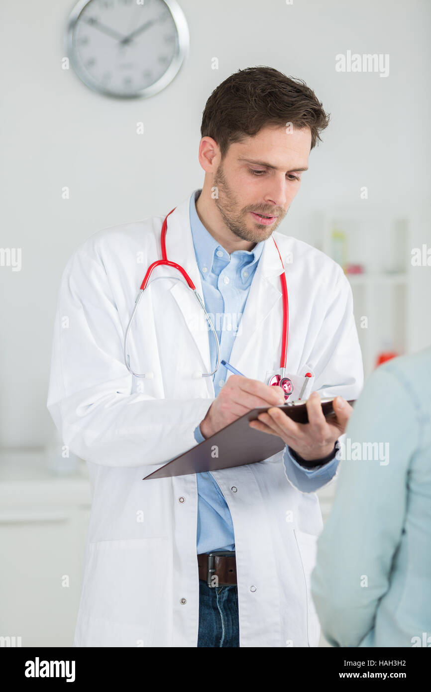 doctor taking notes to diagnose patient Stock Photo - Alamy