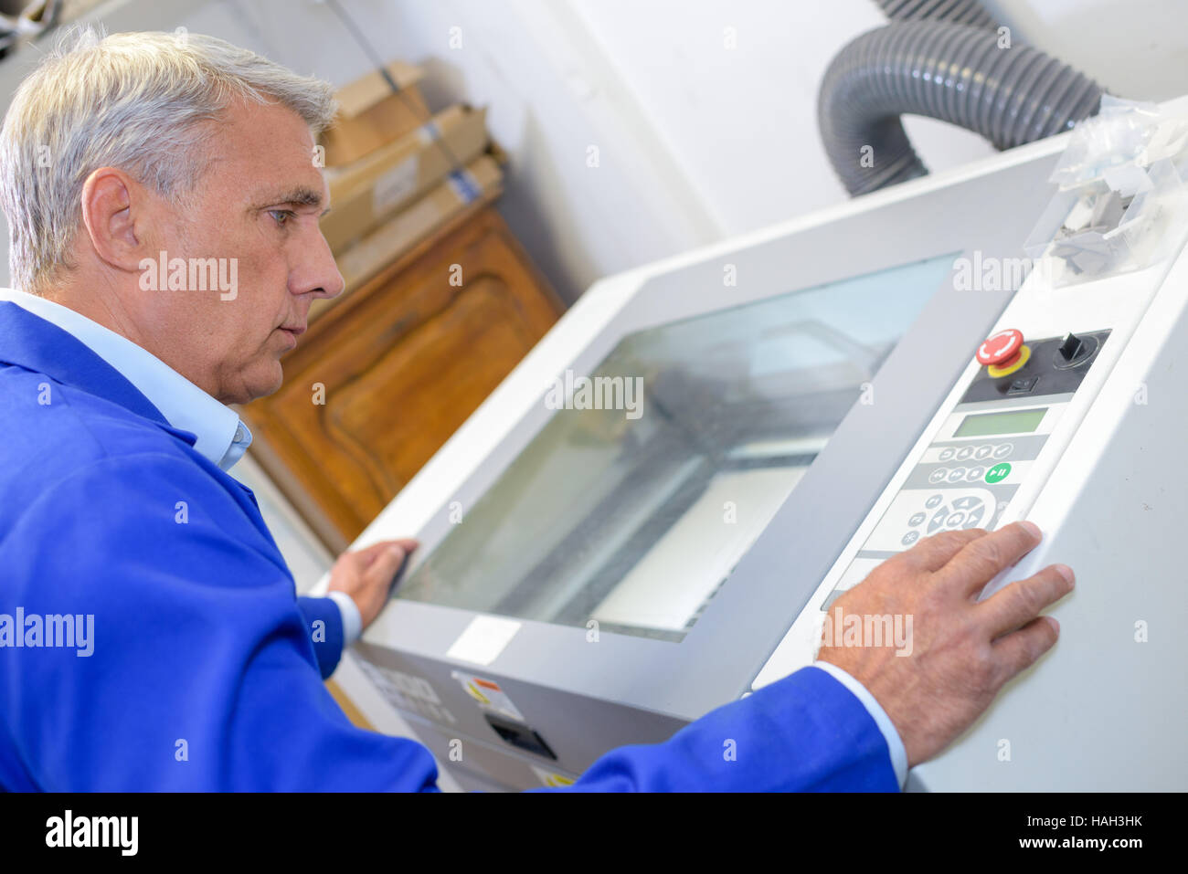 man adjusting a machine Stock Photo - Alamy