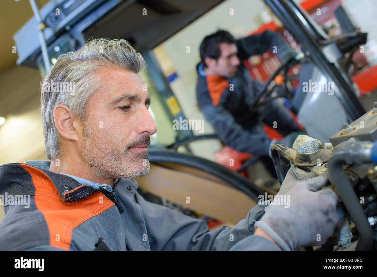fixing a tractor Stock Photo - Alamy