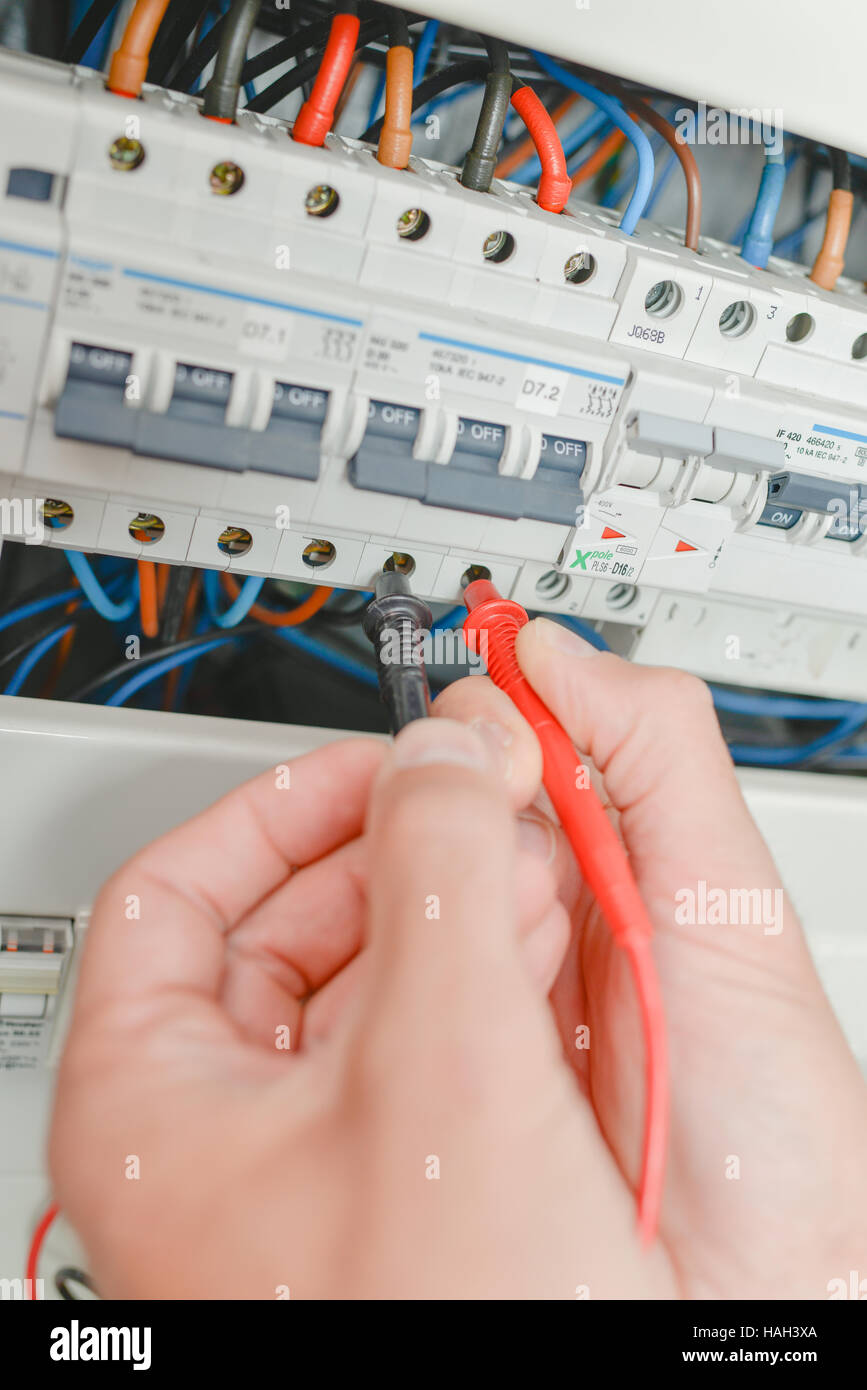 Connecting probes of multimeter to fusebox Stock Photo - Alamy