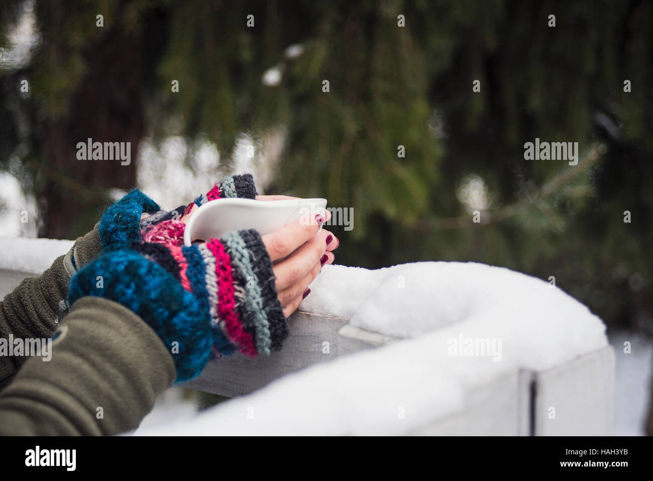 Girl drinking tea outside during snow day Stock Photo - Alamy