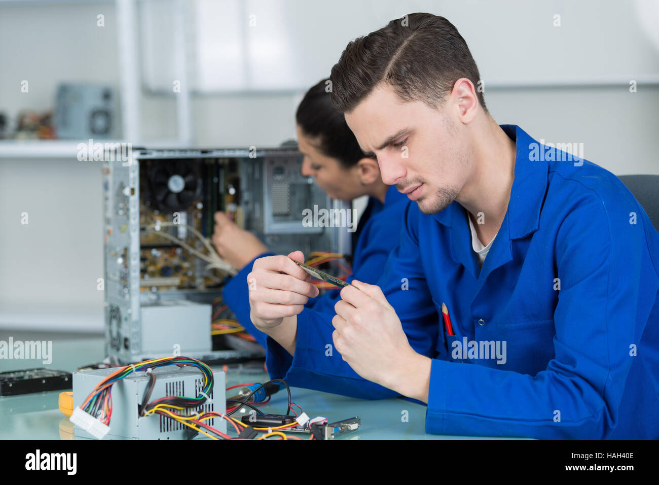team of students examining and repairing computer parts Stock Photo - Alamy