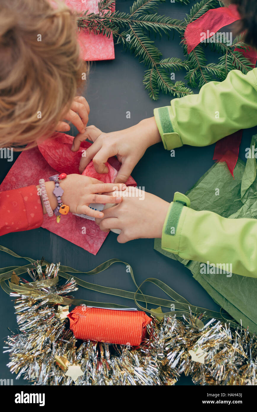 Children wrapping a gift Stock Photo - Alamy