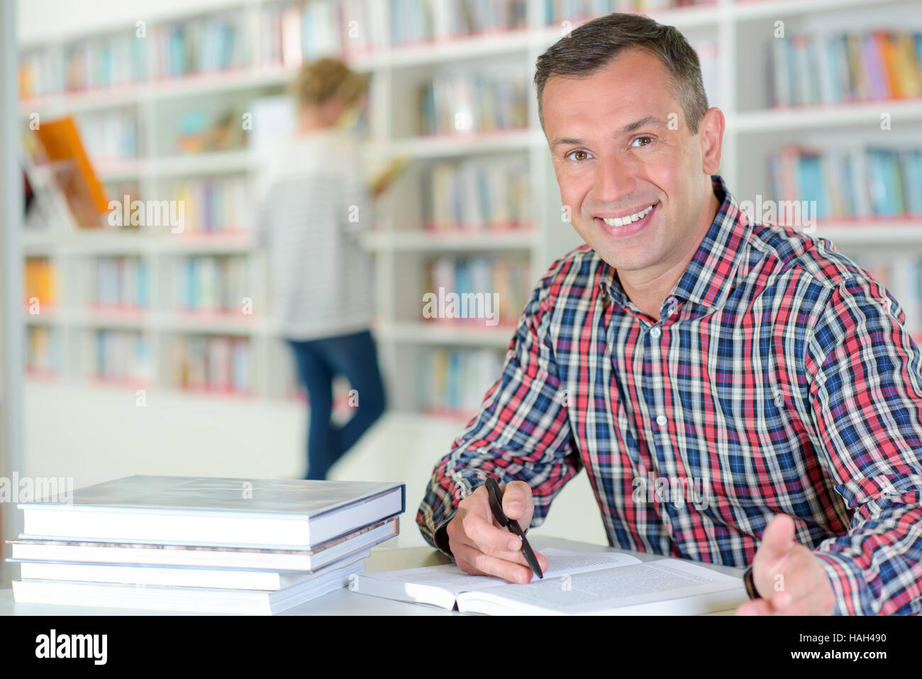 Portrait of man in library Stock Photo - Alamy