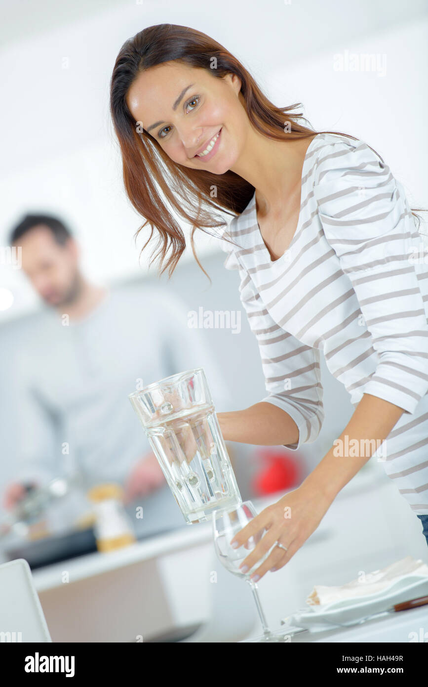 Woman setting the dining table Stock Photo - Alamy