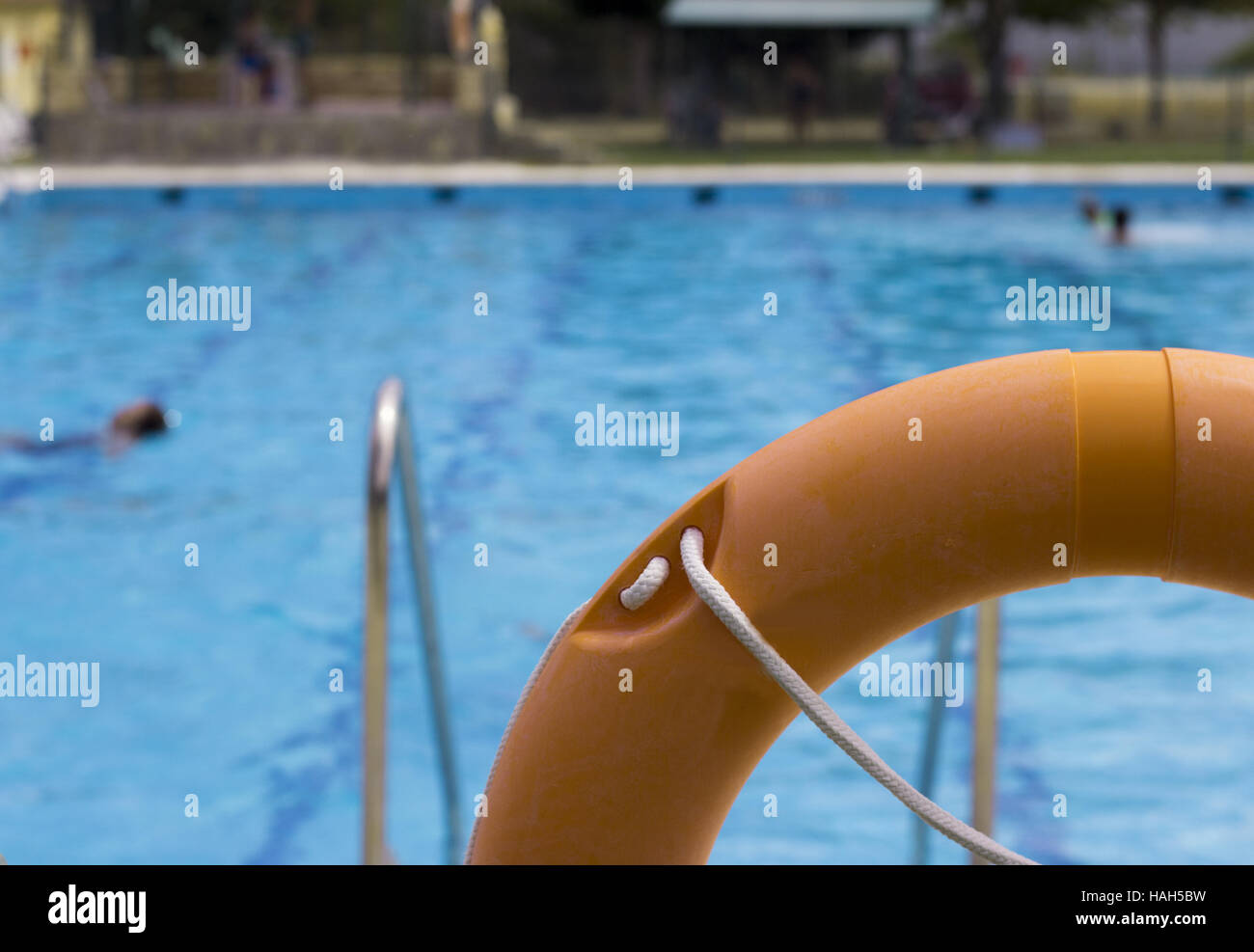 Orange life float. View of pool in the background unfocused Stock Photo ...
