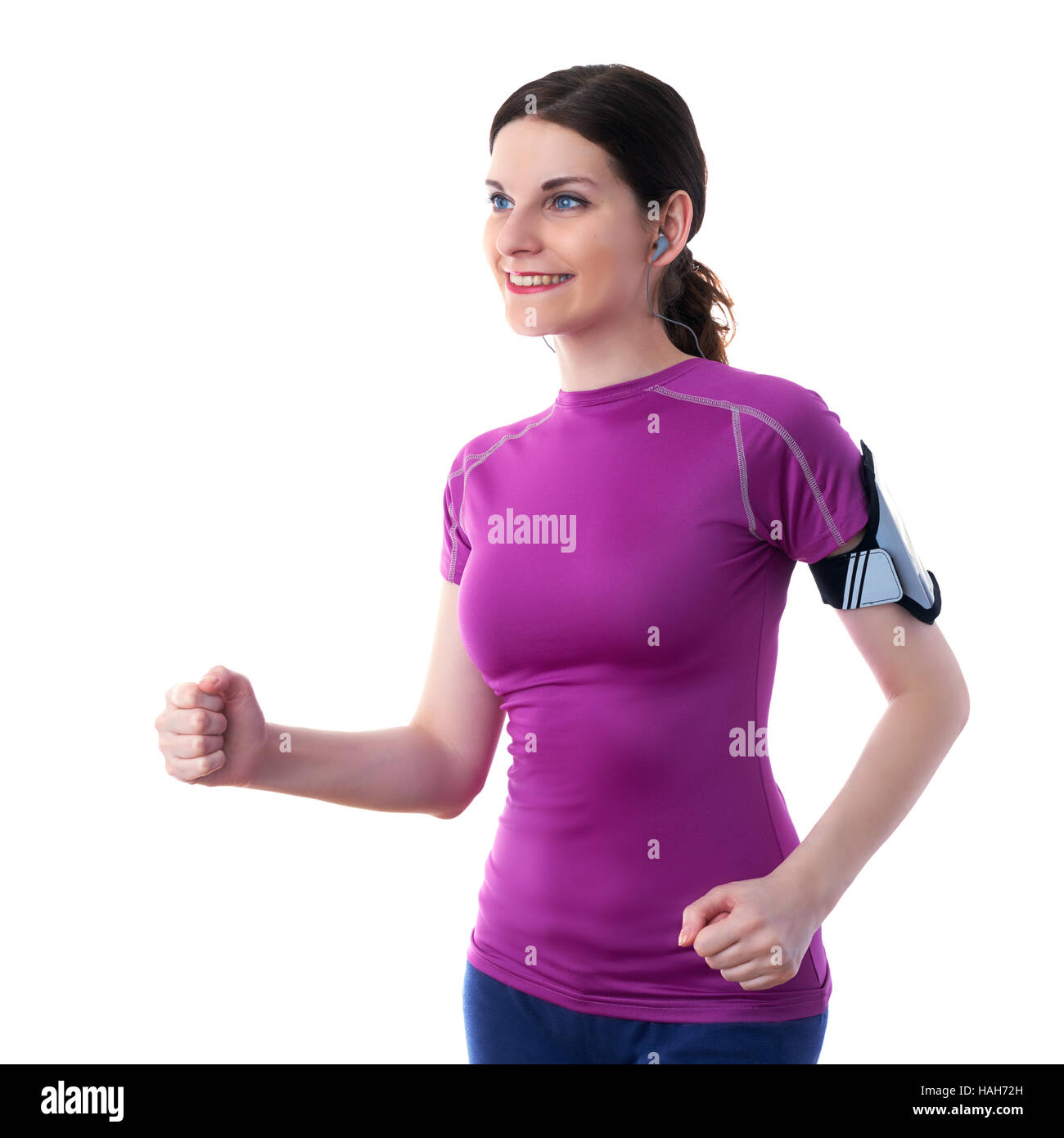 Smiling sporty woman in violet T-short over white isolated background ...
