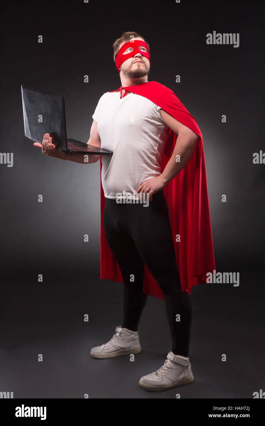 Super hero man with laptop computer Stock Photo - Alamy