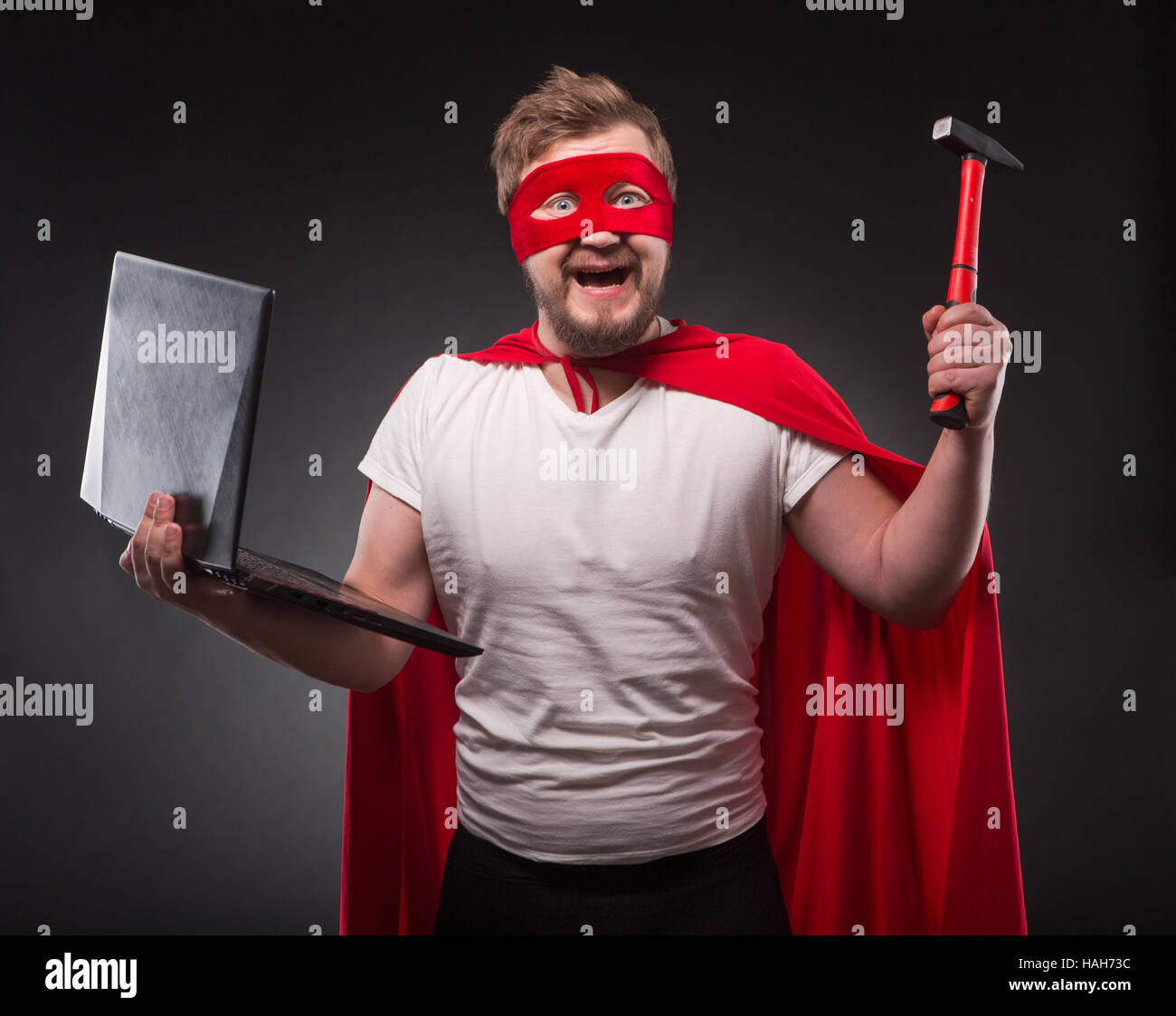 Super hero man with laptop computer Stock Photo - Alamy