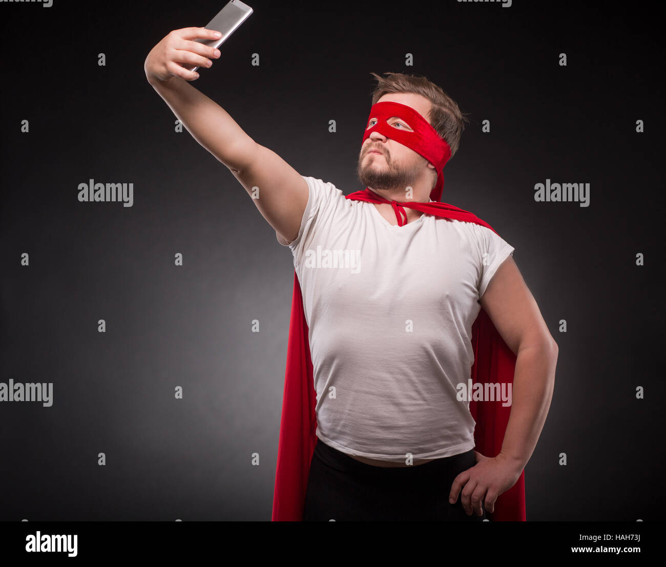 Super hero man with laptop computer Stock Photo - Alamy