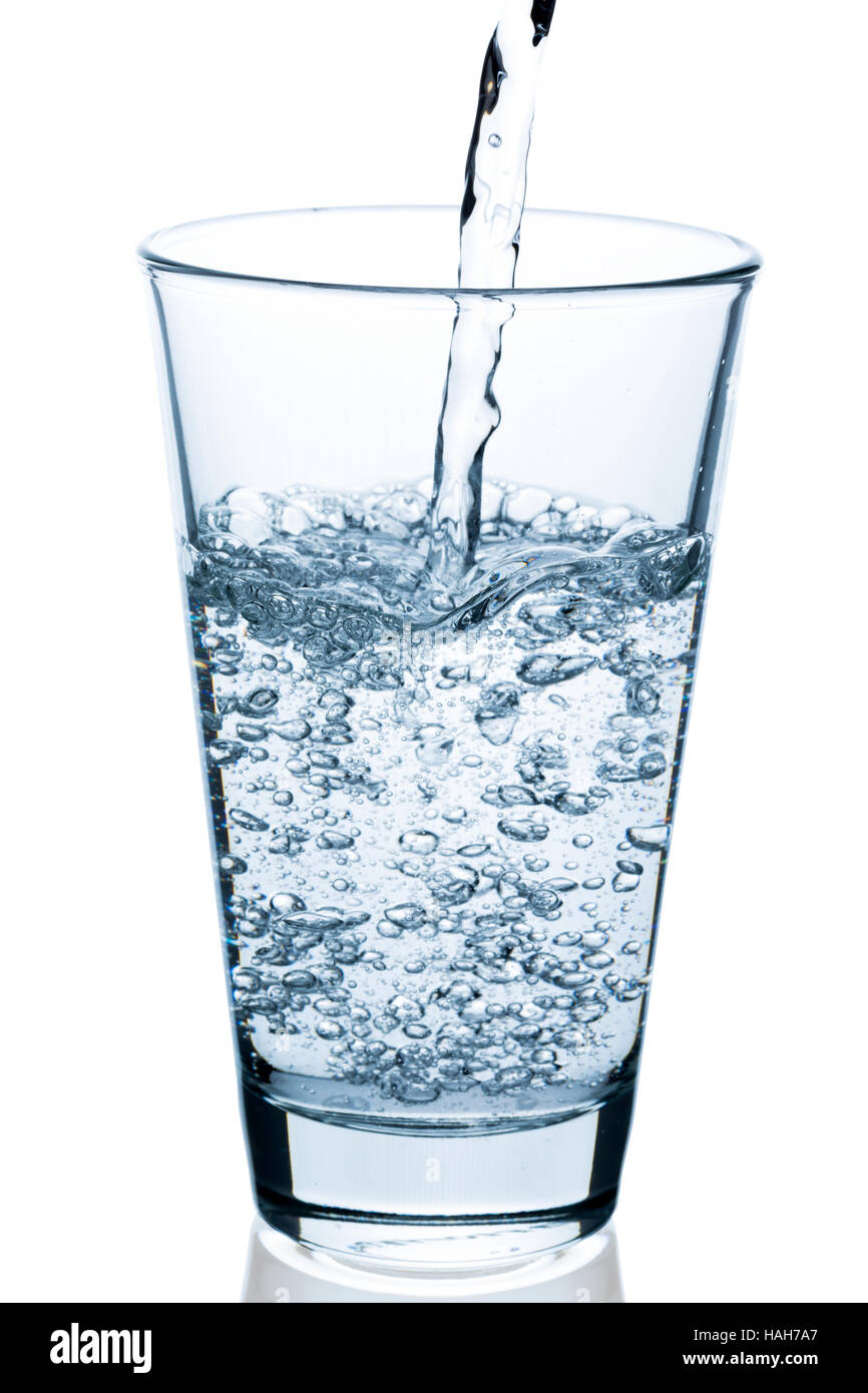pouring bubbling water into glass isolated on white background Stock ...