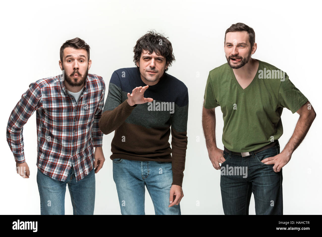 The three men are smiling, looking at camera Stock Photo - Alamy