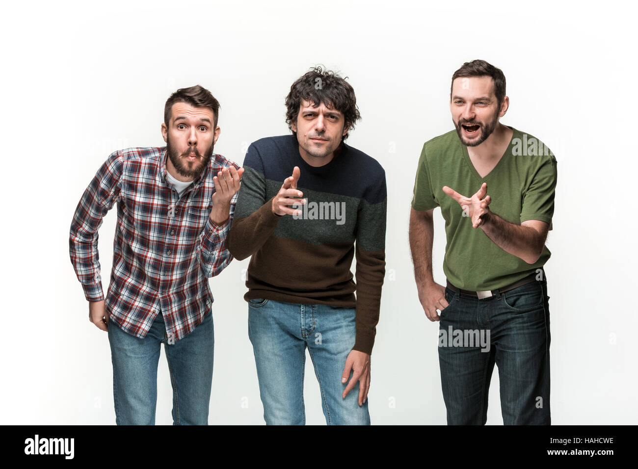The three men are smiling, looking at camera Stock Photo - Alamy