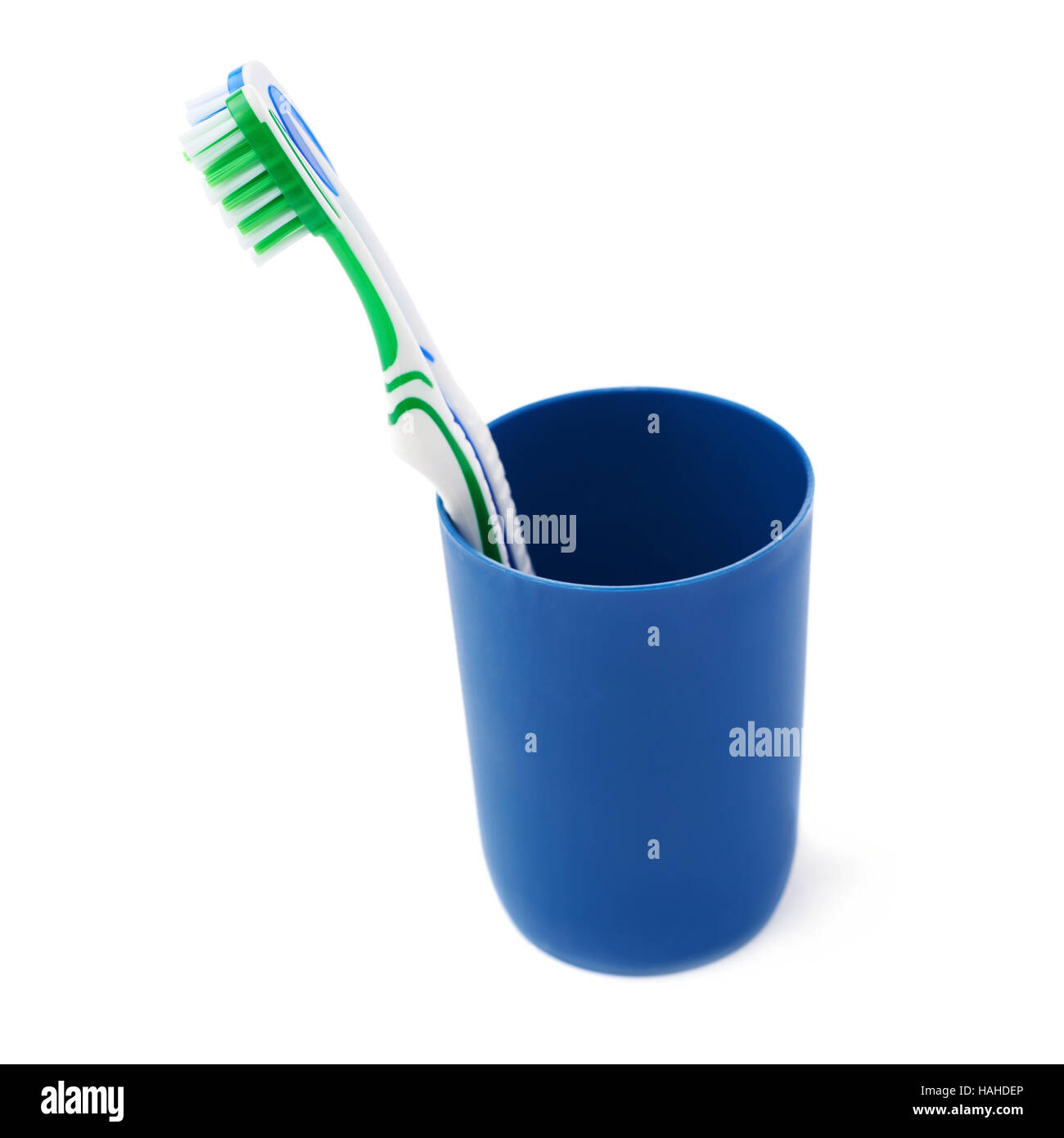 Toothbrush in blue plastic cup isolated over white background Stock ...