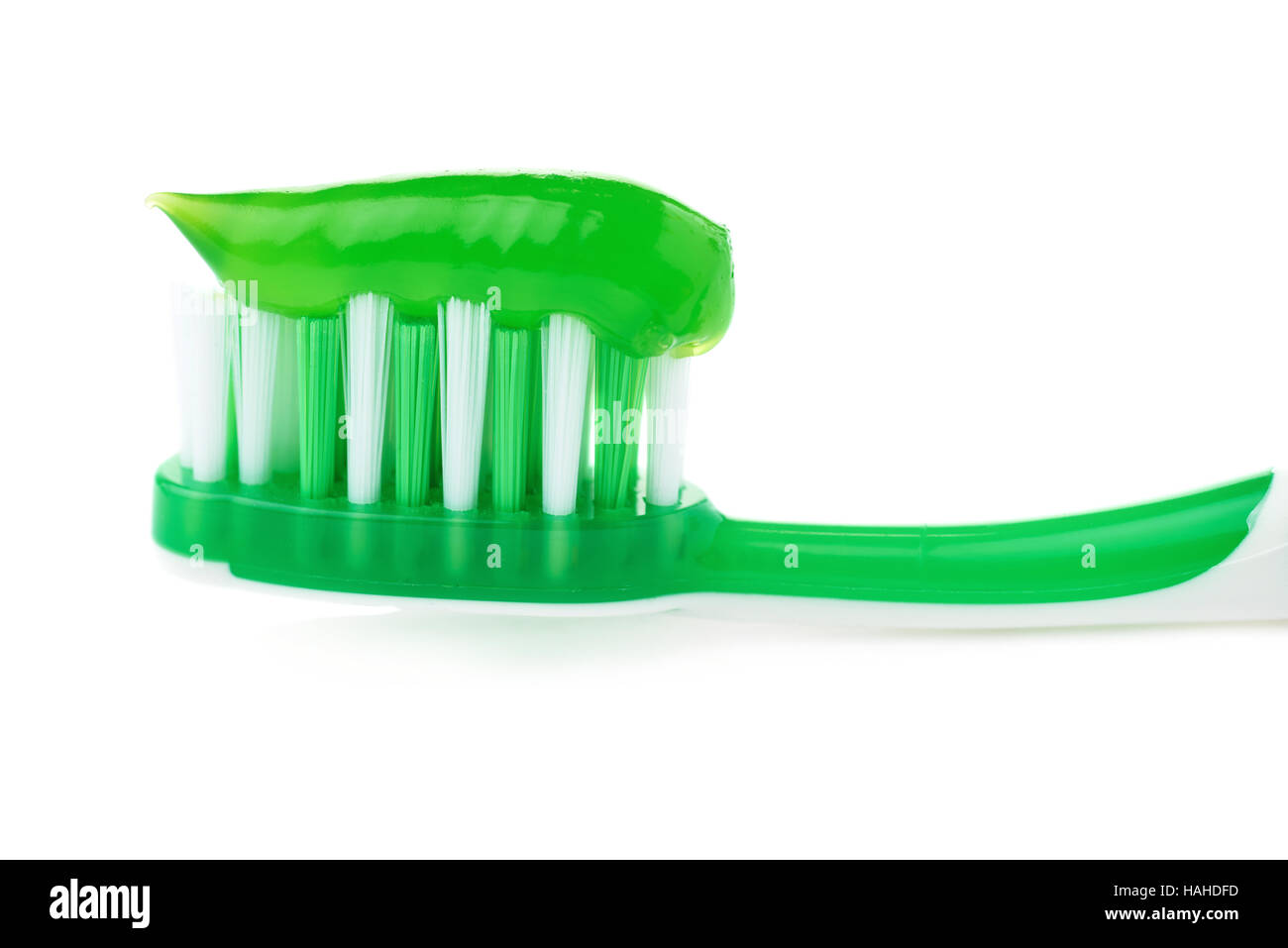 Green toothbrush with paste isolated over white background Stock Photo ...
