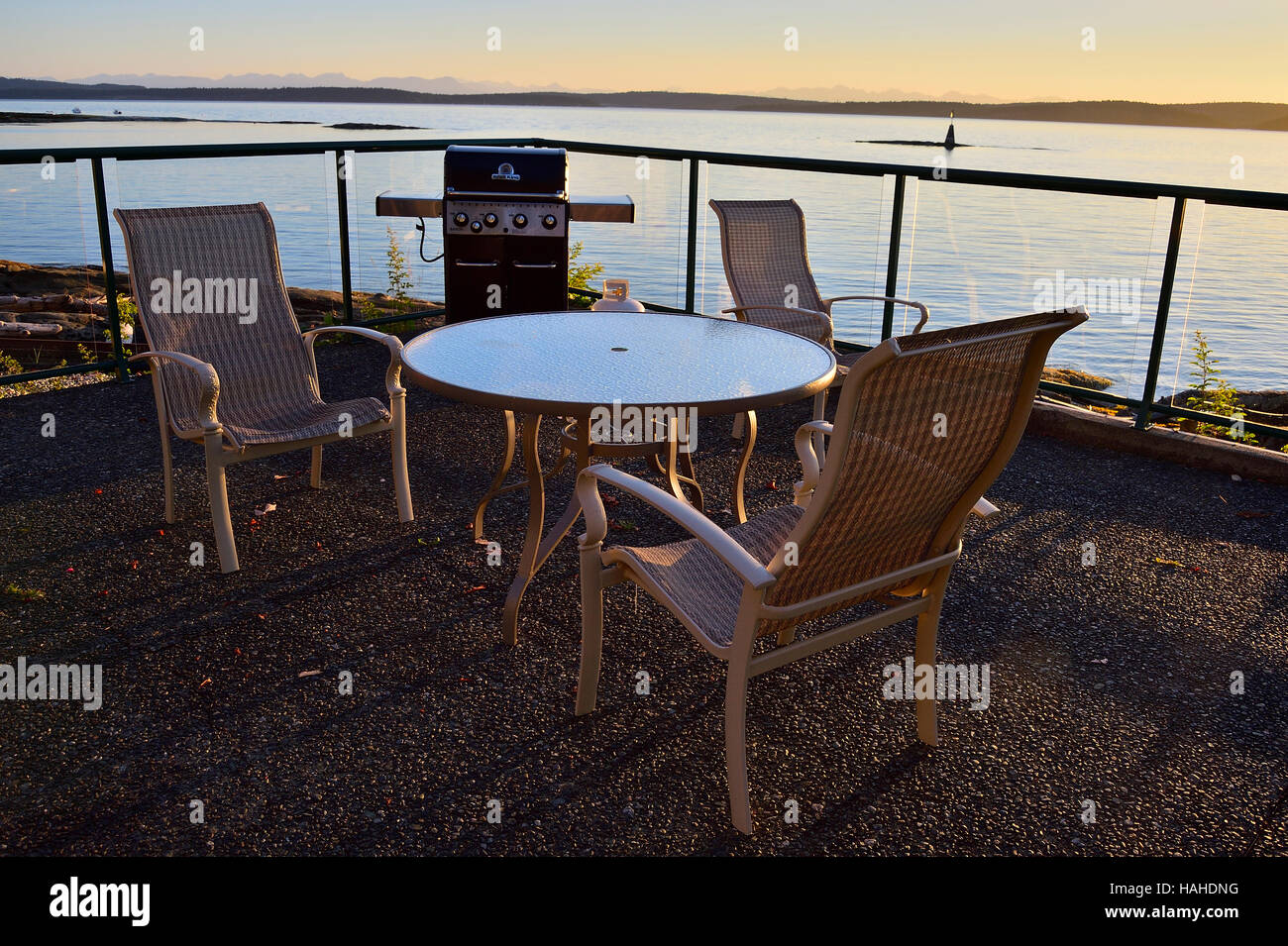 A table and chairs waiting for people to sit and relax Stock Photo - Alamy