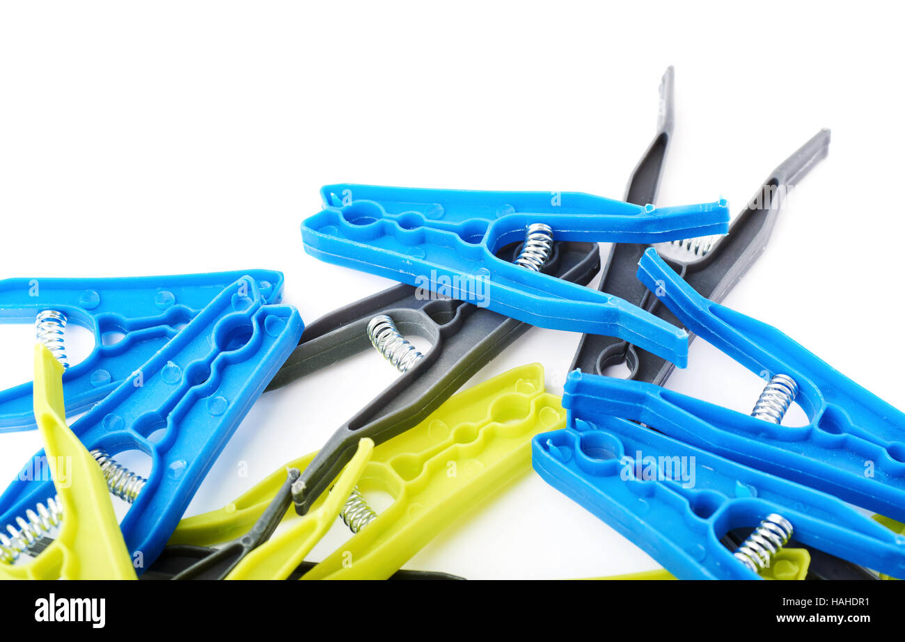 Pile of cloth pegs isolated over white background Stock Photo - Alamy