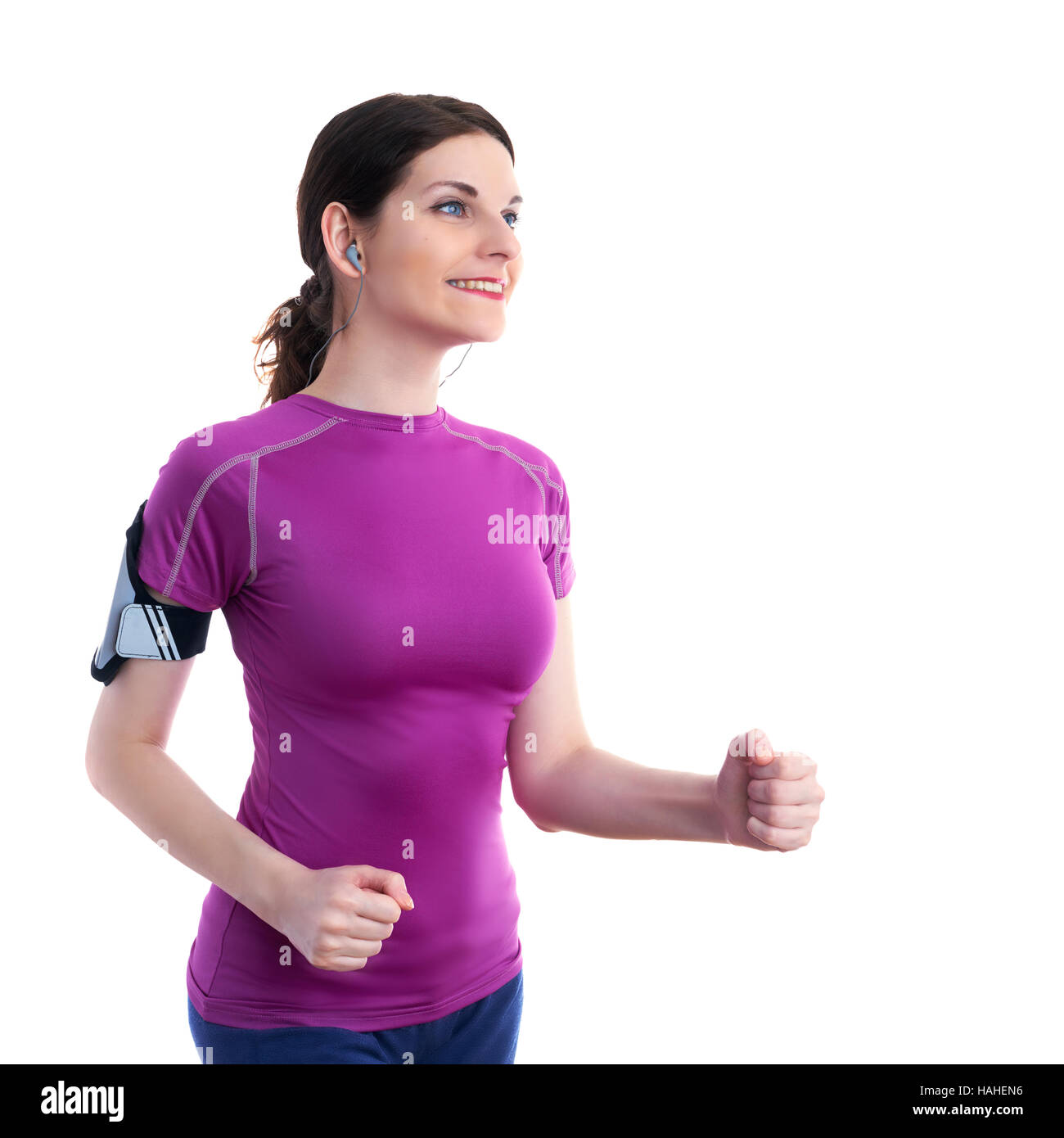 Smiling sporty woman in violet T-short over white isolated background ...