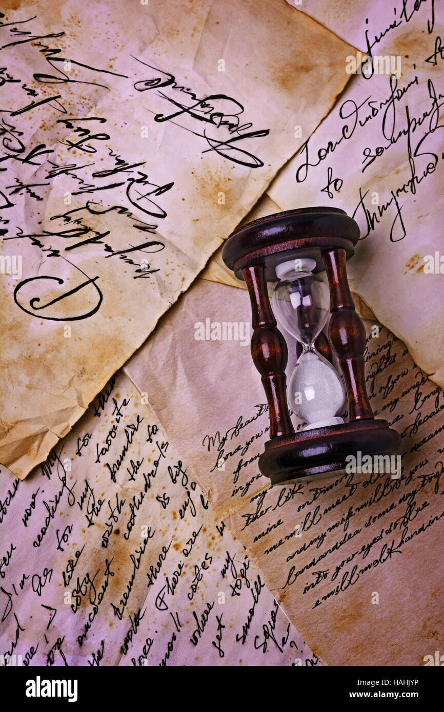 Vintage Hourglass or sandglass on handwriting letters background Stock ...