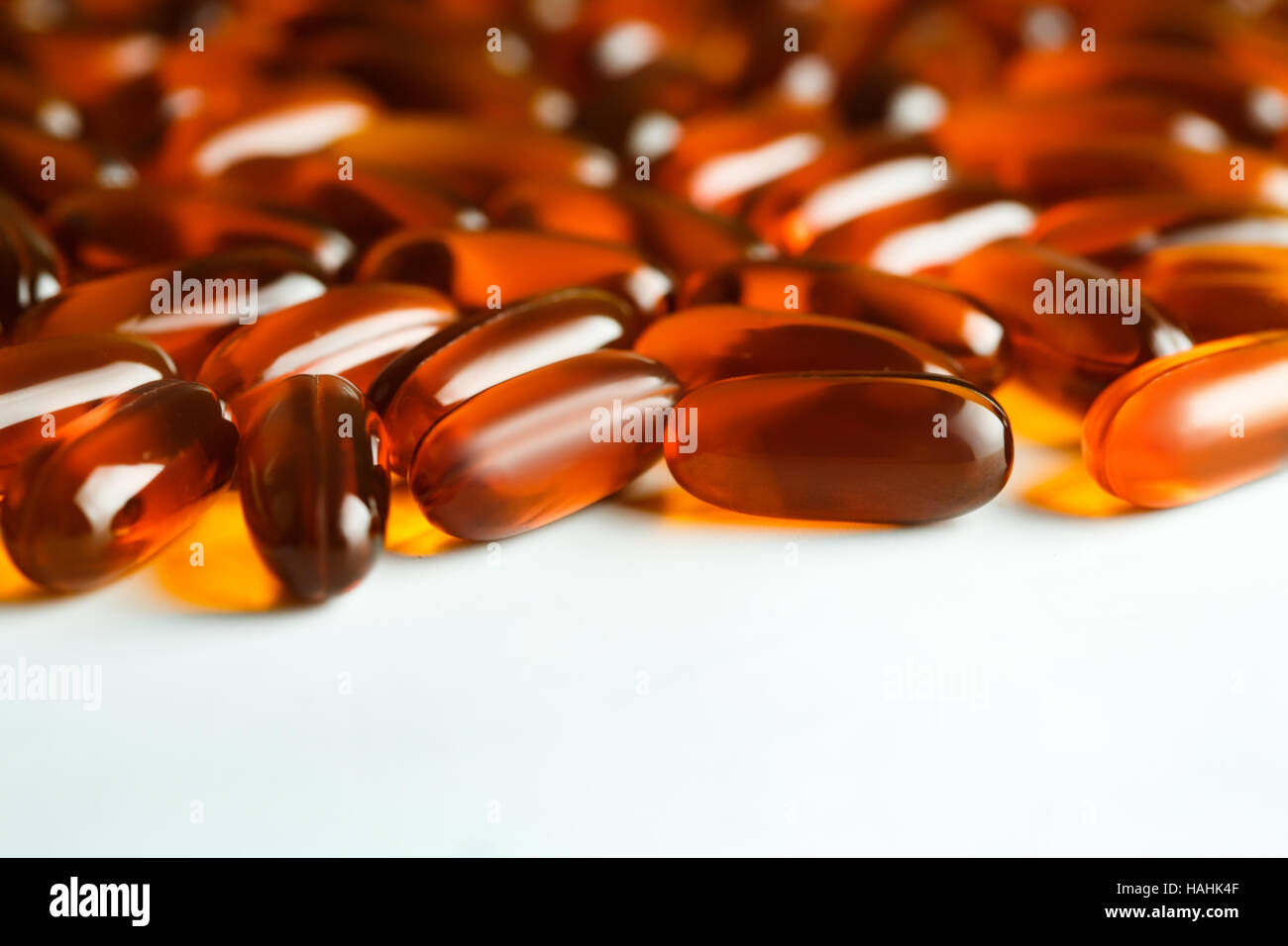 Gel capsules scattered on white background, selective focus, copy space ...