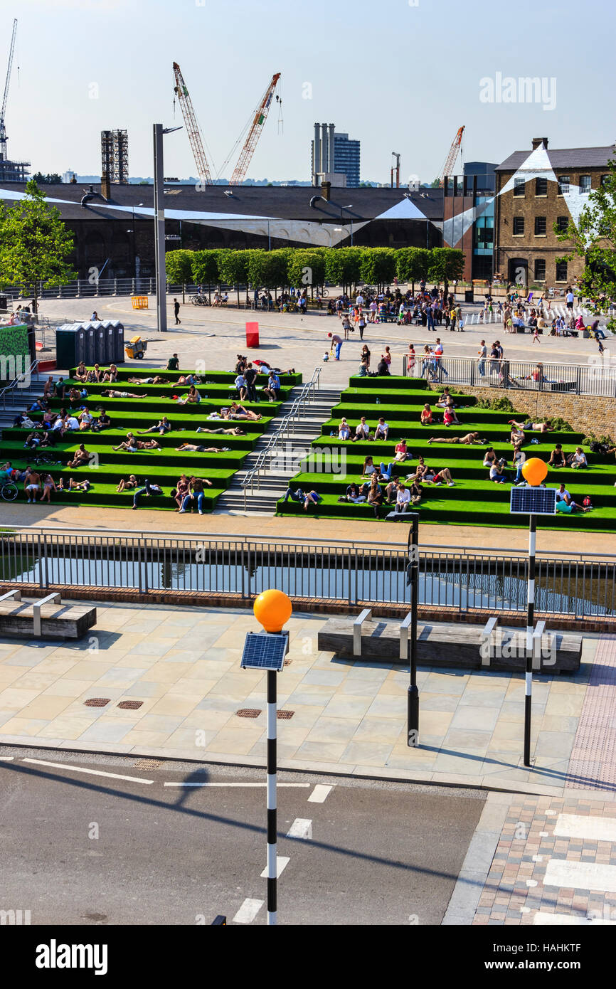 Sunbathers on the artificial-grassed steps of Granary Square by Regent ...