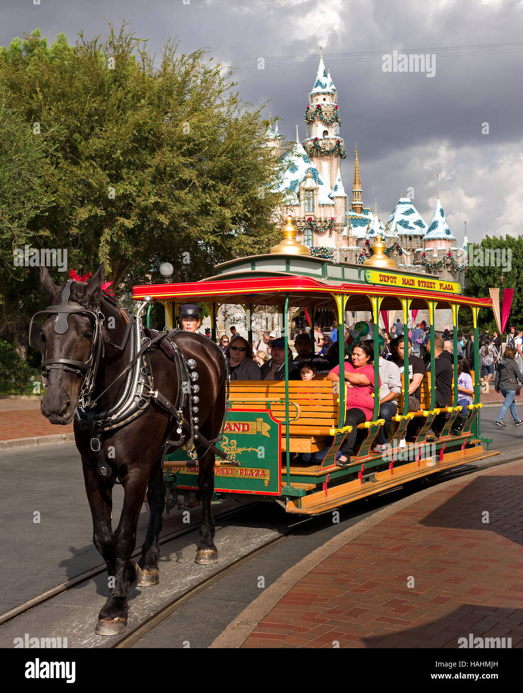 A horse pulls visitors to Disneyland in a horse drawn trolley car Stock ...