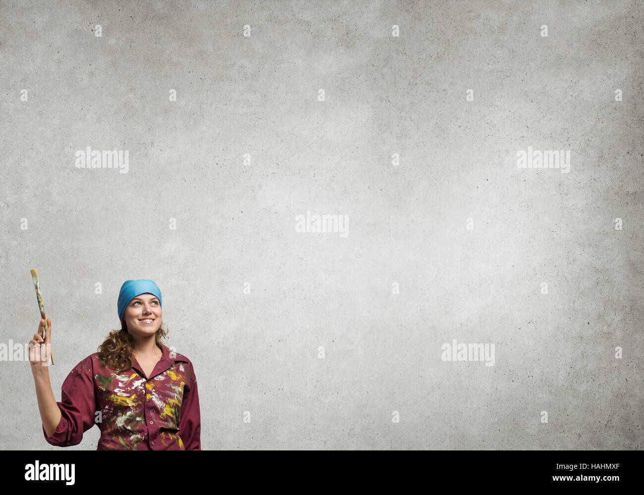 Young pretty artist woman with paint brush in hand Stock Photo - Alamy