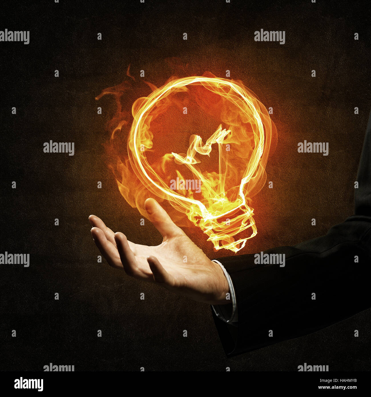 Close of businessman hand holding glowing fire light bulb icon Stock ...