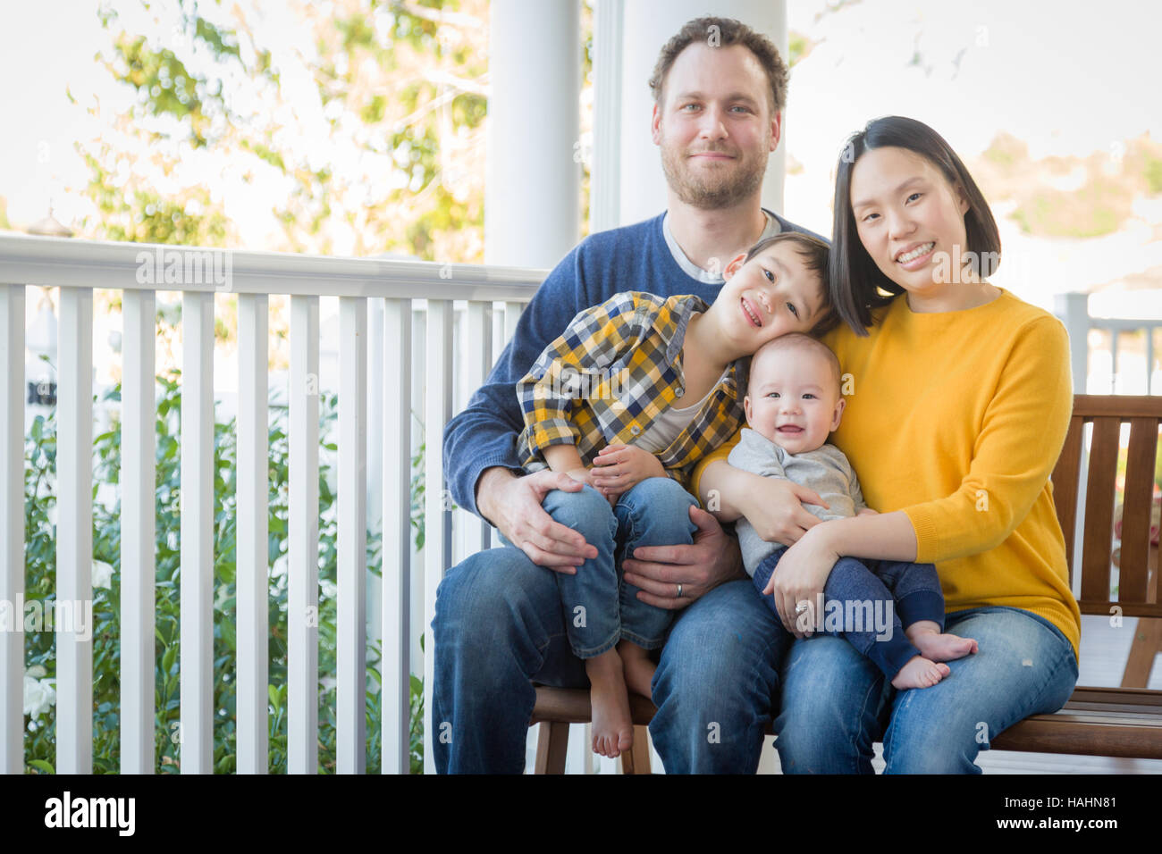 Young Mixed Race Chinese and Caucasian Family Portrait On Their Front ...