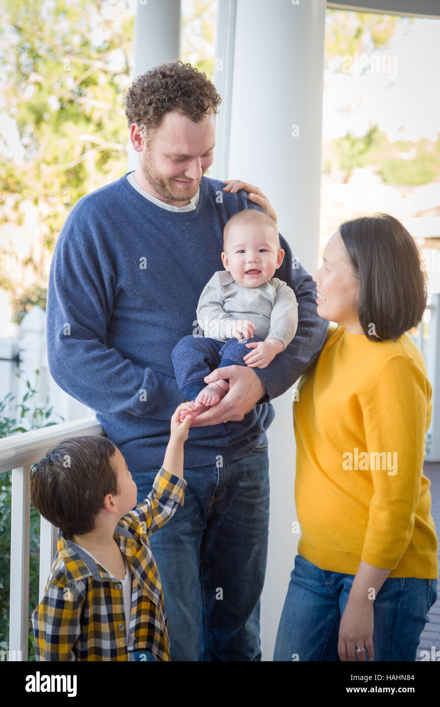 Young Mixed Race Chinese and Caucasian Family Portrait On Their Front ...