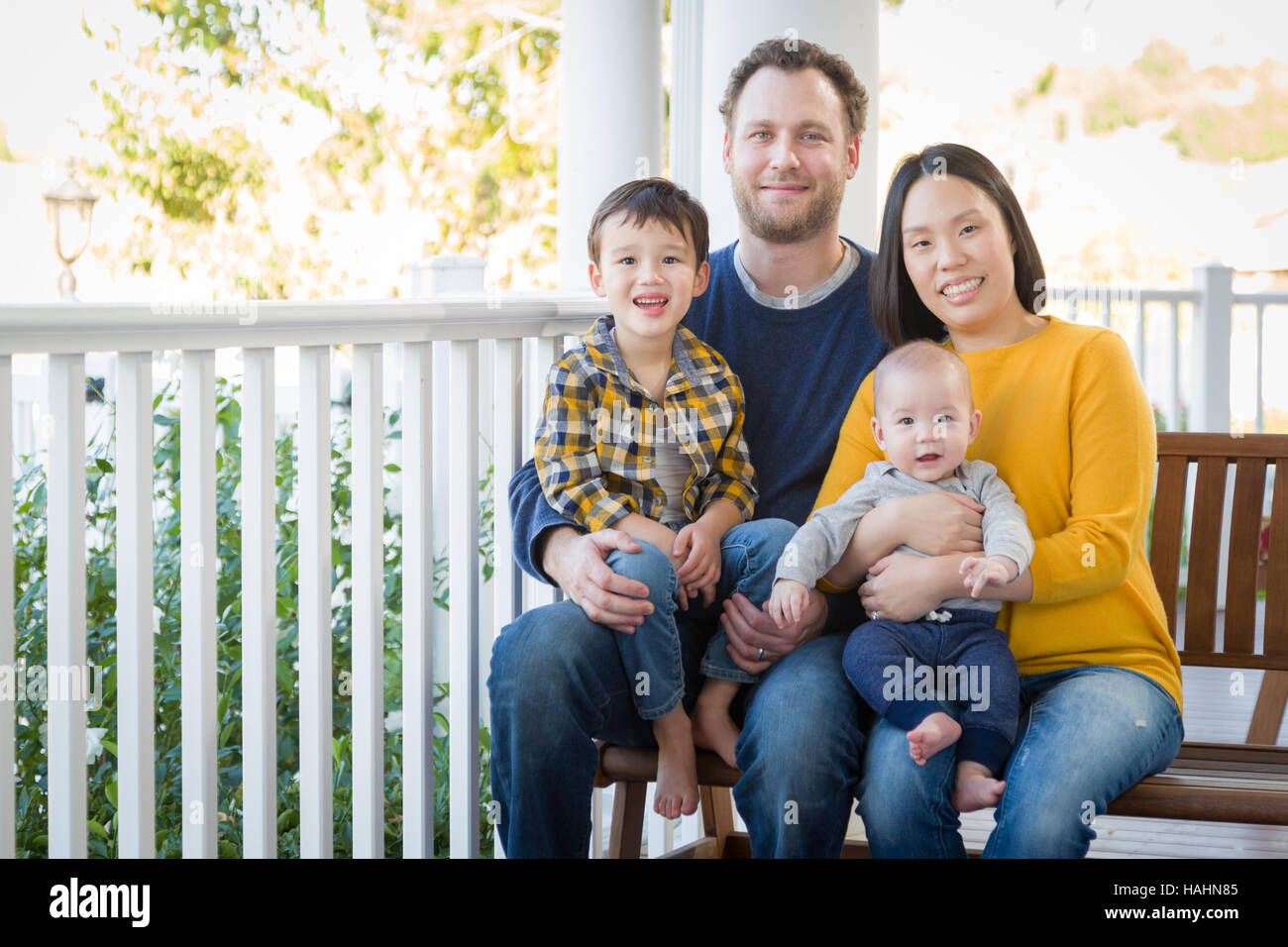 Young Mixed Race Chinese and Caucasian Family Portrait On Their Front ...