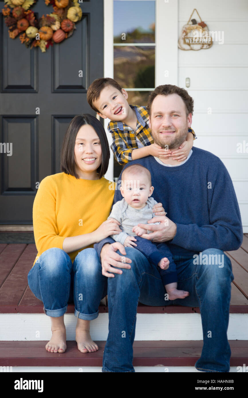 Young Mixed Race Chinese and Caucasian Family Portrait On Their Front ...