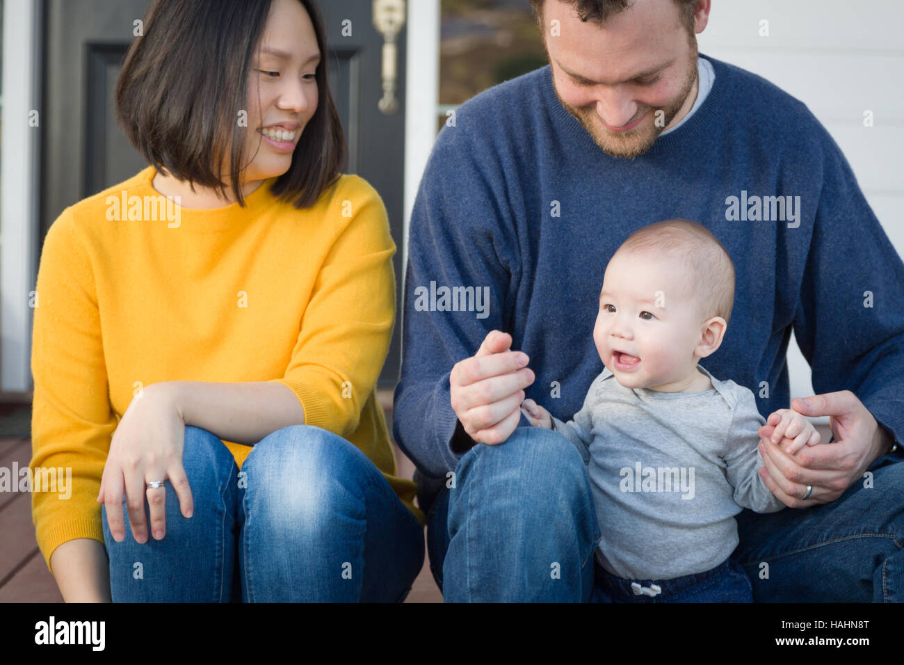 Young Mixed Race Chinese and Caucasian Family Portrait On Their Front ...