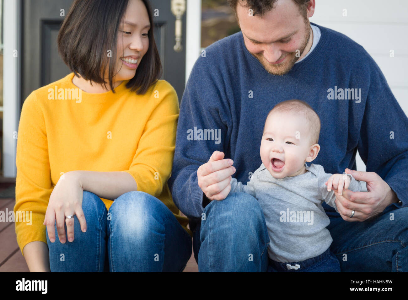 Young Mixed Race Chinese and Caucasian Family Portrait On Their Front ...