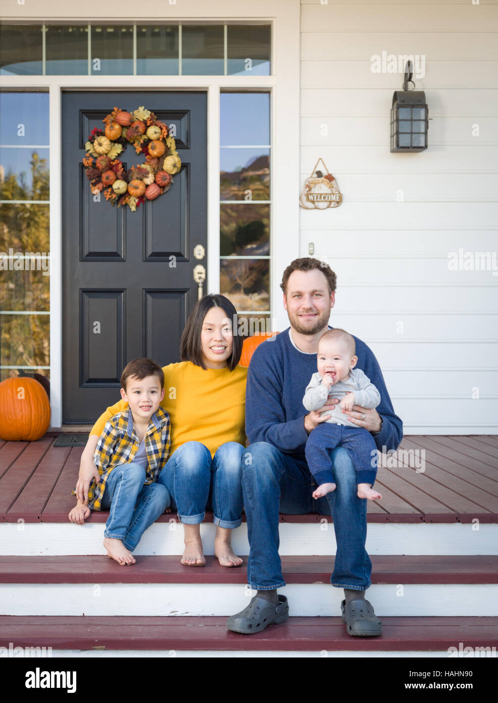 Young Mixed Race Chinese and Caucasian Family Portrait On Their Front ...