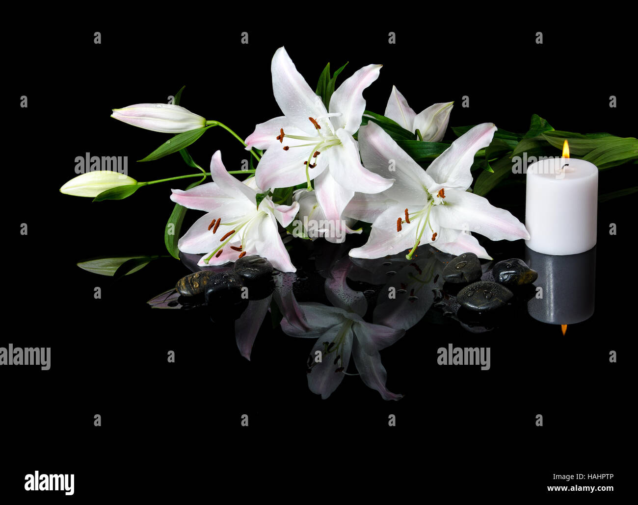 Still life with lilies and candle Stock Photo - Alamy