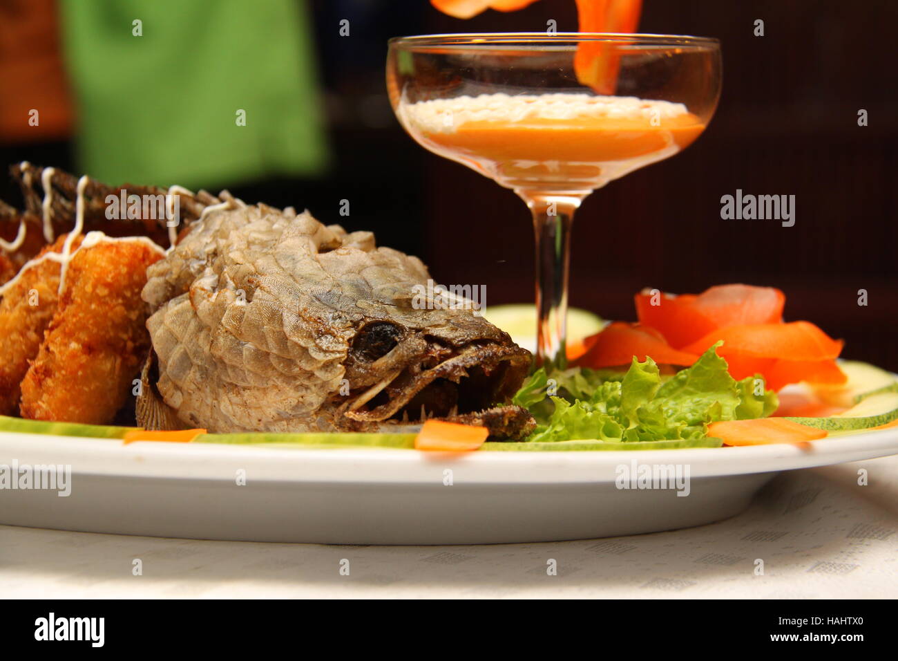 Fried snake head fish with sauce and salad on white dish Stock Photo ...