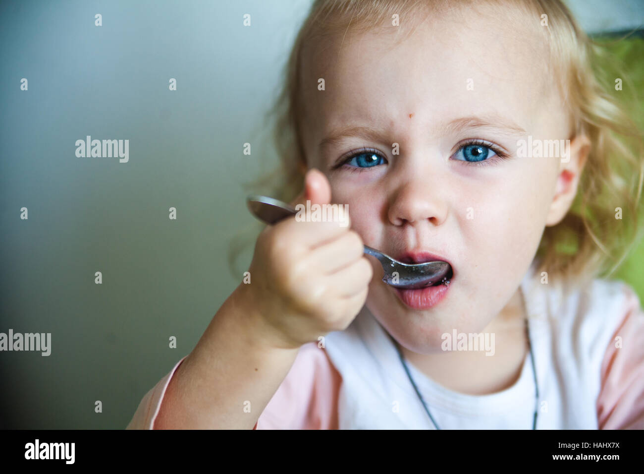 little Cute girl eating Stock Photo - Alamy