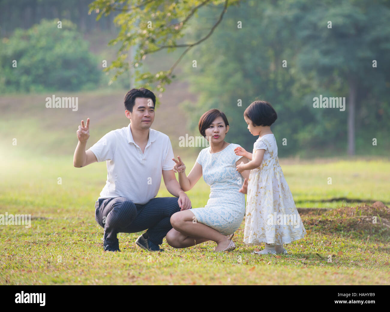 Happy Asian Family enjoying family time together in the park Stock Photo - Alamy
