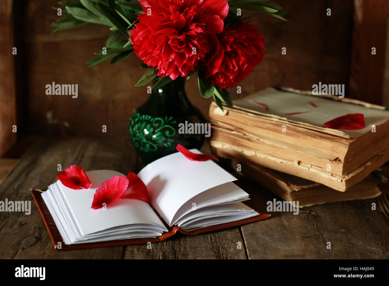 old book flower on wooden table Stock Photo - Alamy