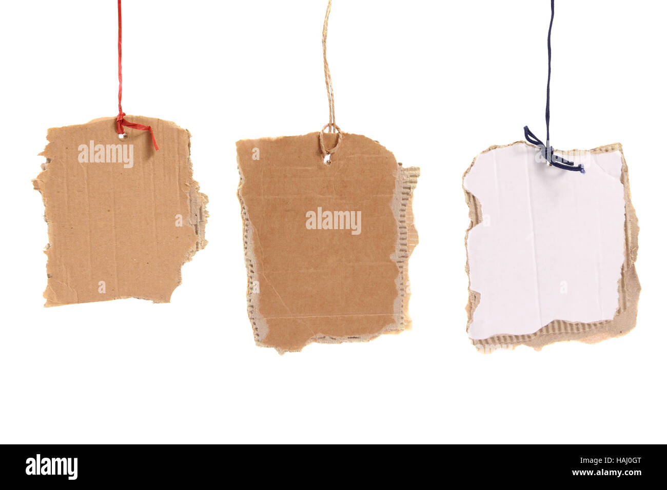 Three cardboard tags hanging on white background Stock Photo - Alamy