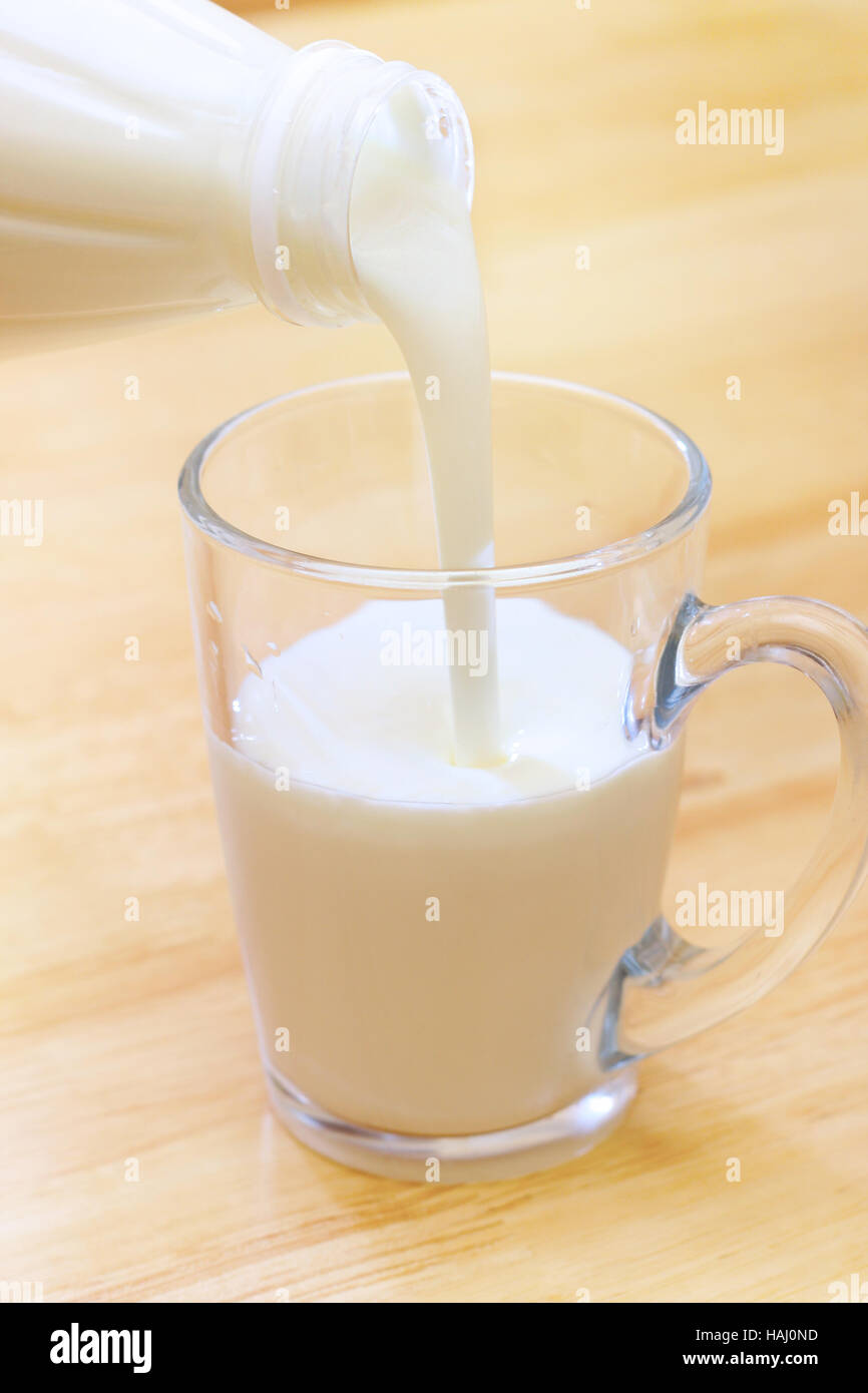 Pouring yoghurt into a glass Stock Photo - Alamy