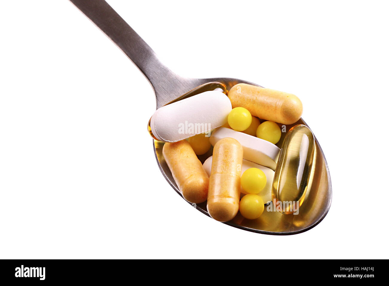 spoon with tablets and capsules isolated on white background Stock ...